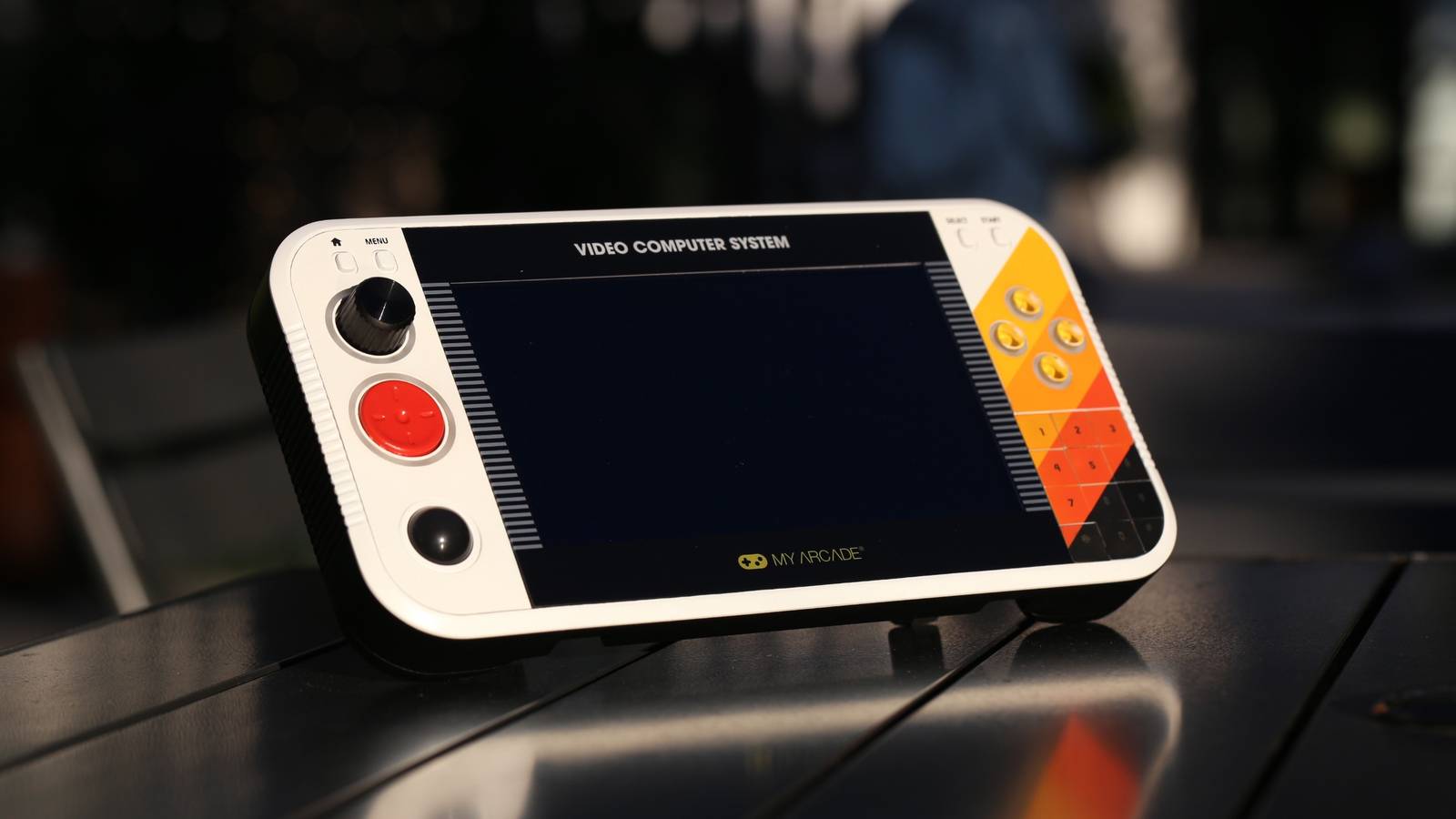 This retro gaming handheld packs classic Atari controllers and a keypad